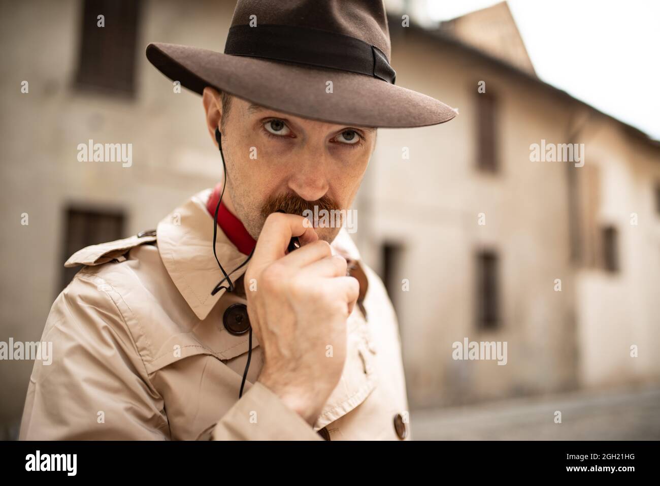 Detective walking alone in the city slums Stock Photo - Alamy
