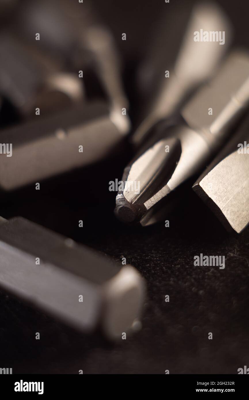 Vertical shot of screwdriver bits on a dark surface Stock Photo - Alamy