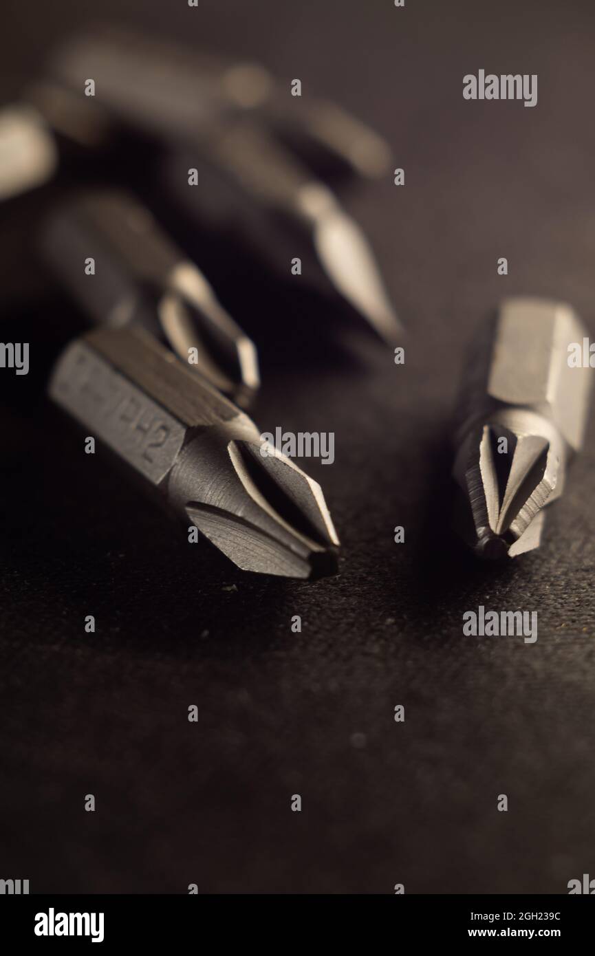 Vertical shot of screwdriver bits on a dark surface Stock Photo - Alamy
