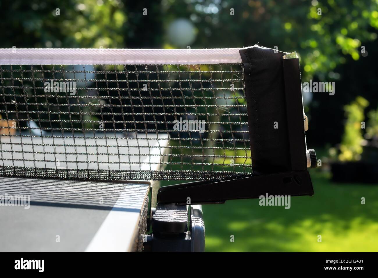 Table tennis or ping pong table, close up. Partial front view of black ...