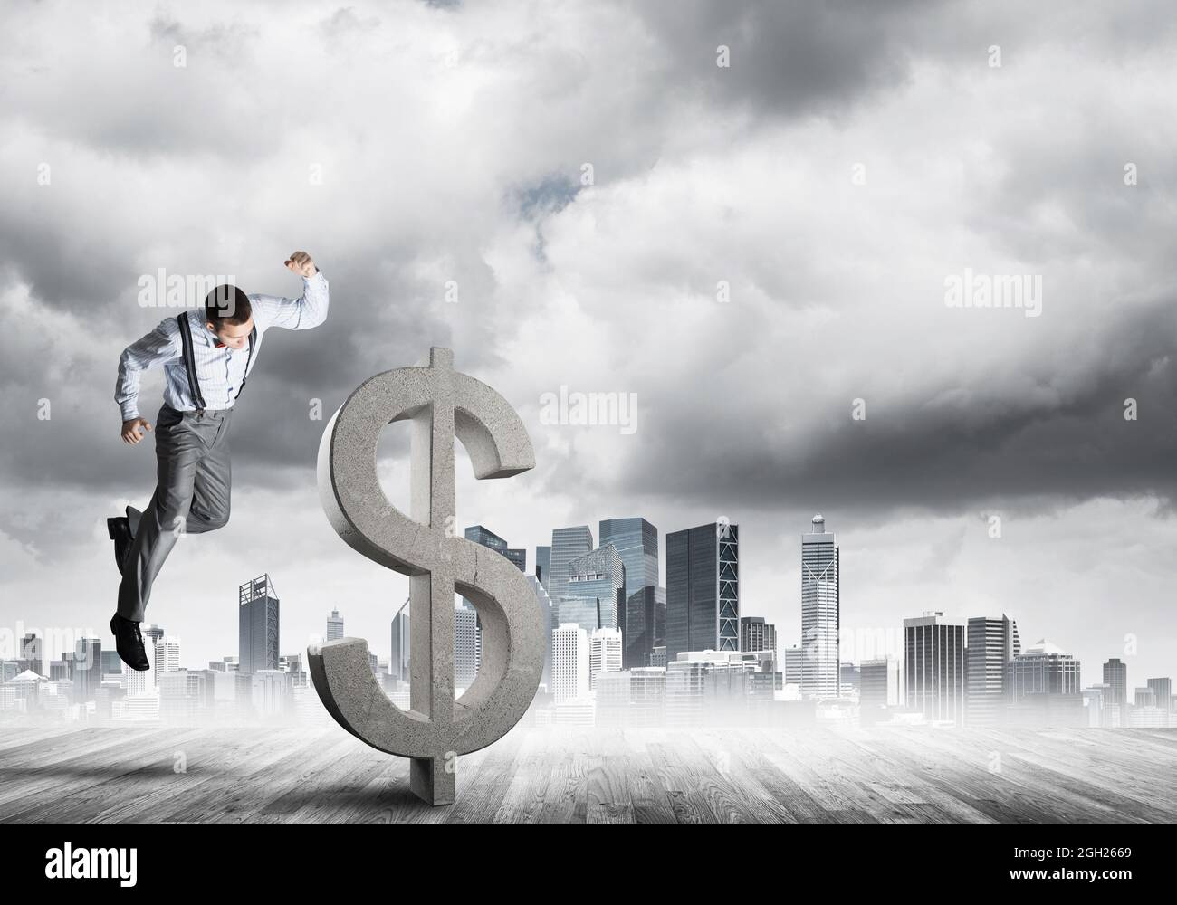 Determined banker man against modern cityscape breaking dollar concrete ...