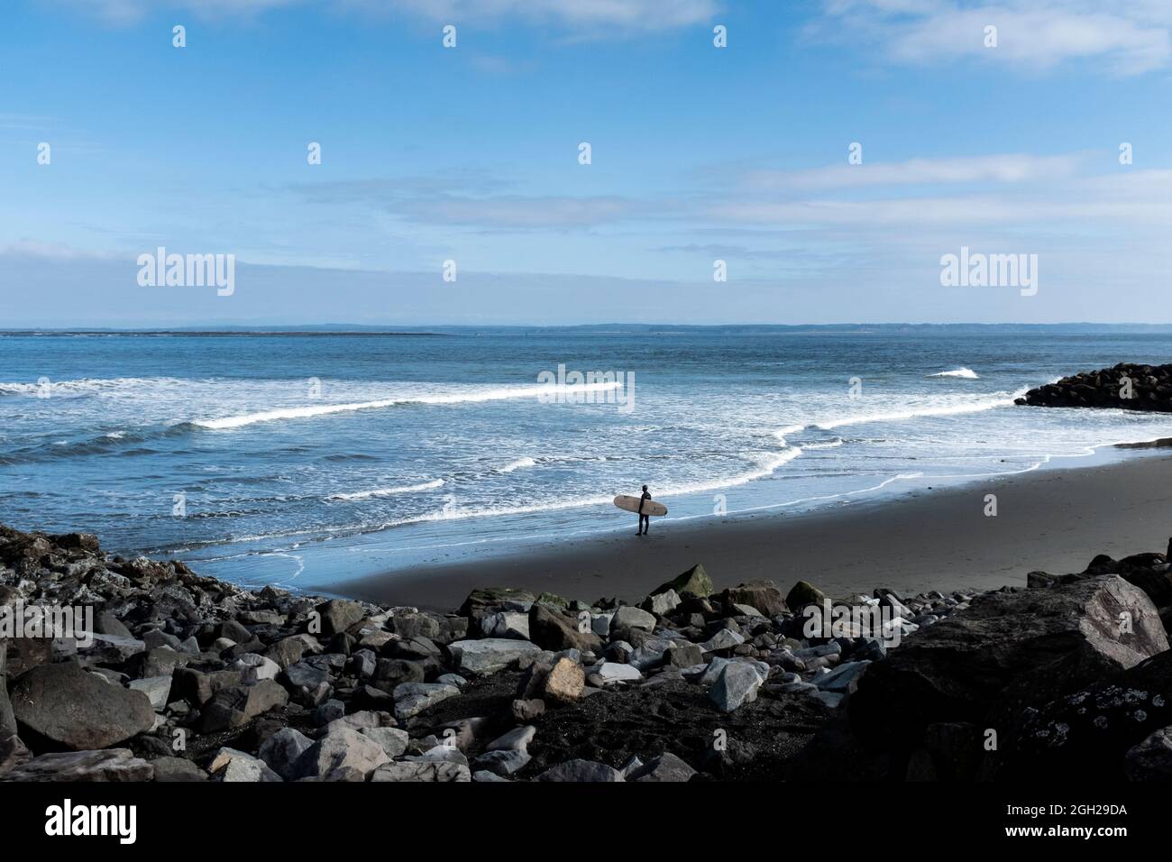 WA20250-00....WASHINGTON - Lone surfer at Grays Harbor Jettys in the ...