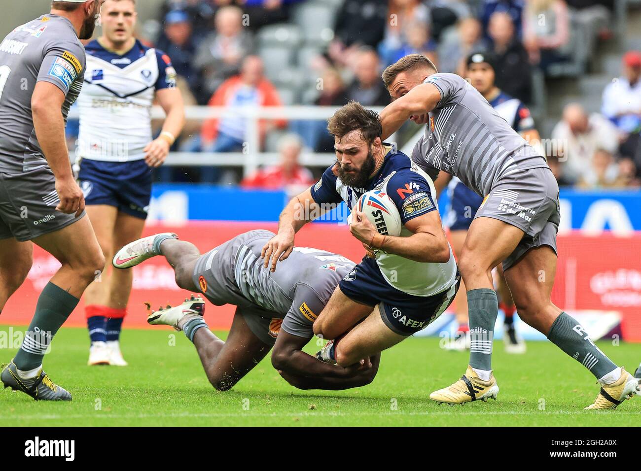 Alex Walmsley (8) of St Helens is tackled by Jordan Dezaria (30) and ...