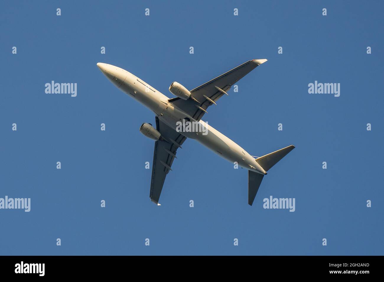 A double engined airliner at flight in a clear, light blue sky Stock ...