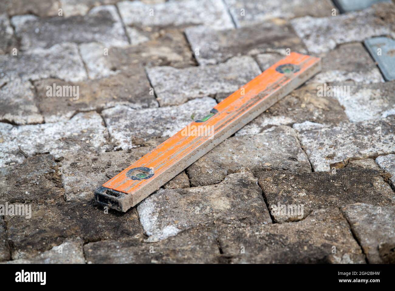 Orange spirit level on newly constructed street work consisting of ...