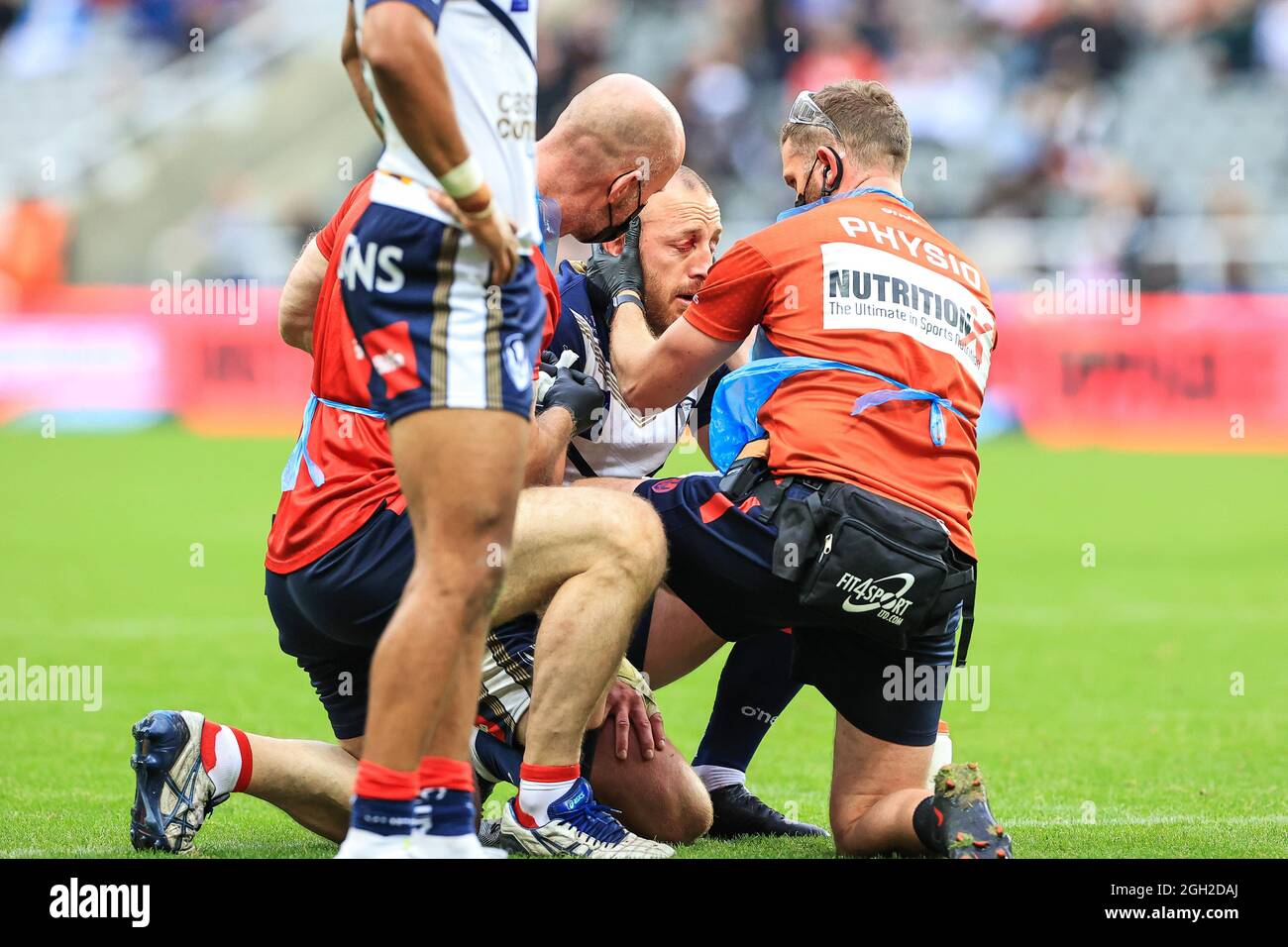 James Roby (9) of St Helens receives treatment for an eye injury Stock ...