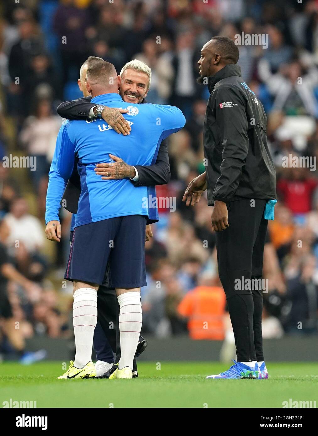 Wayne Rooney greets David Beckham and Usain Bolt before the SoccerAid ...