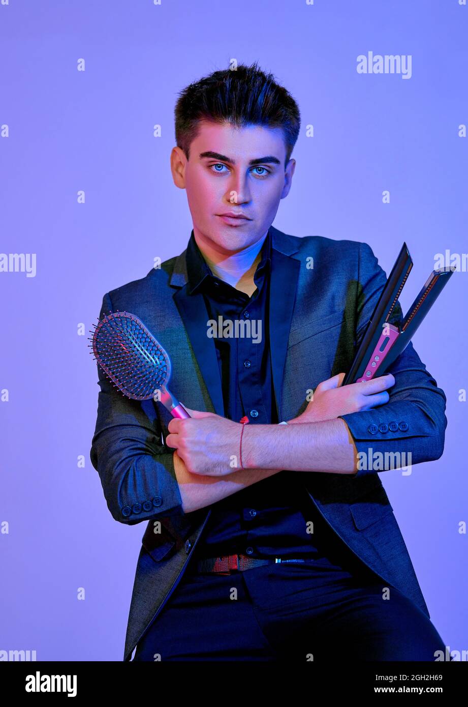 emotional stylist with curling iron Stock Photo - Alamy