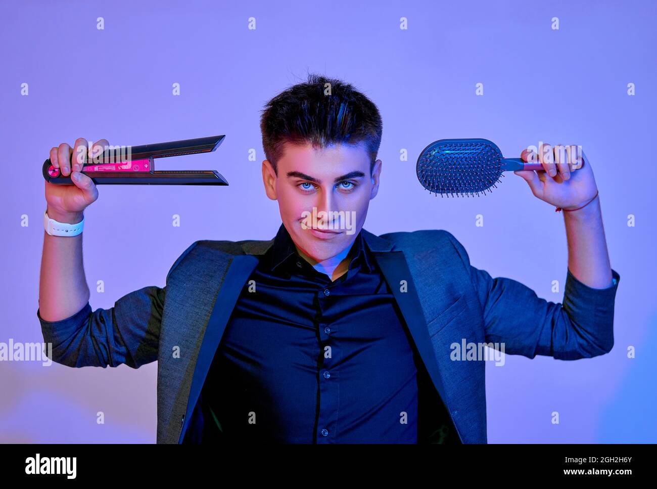 emotional stylist with curling iron Stock Photo - Alamy