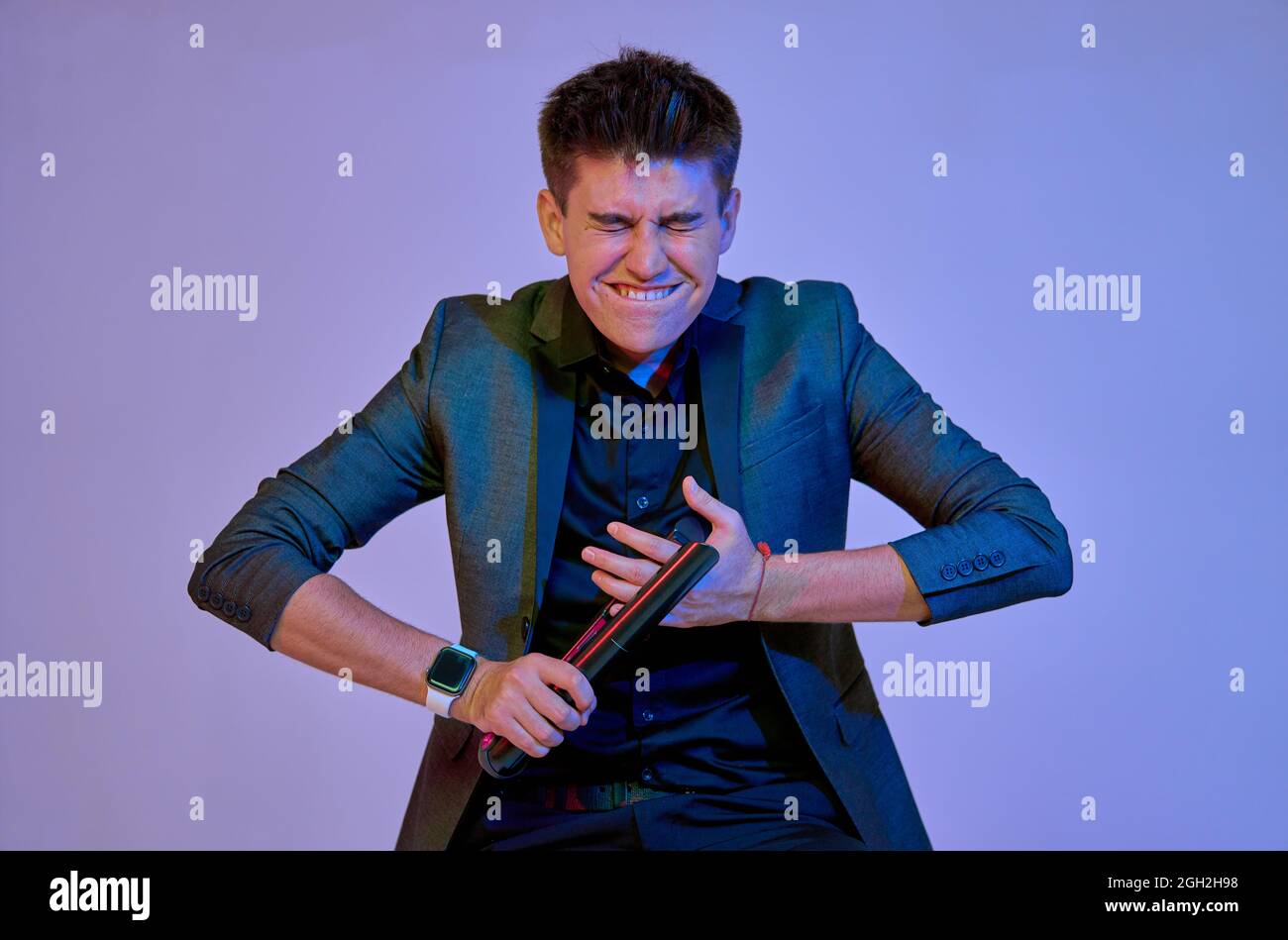 emotional stylist with curling iron Stock Photo - Alamy