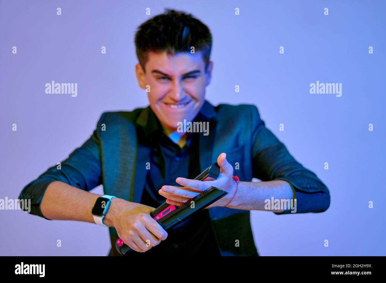 emotional stylist with curling iron Stock Photo - Alamy