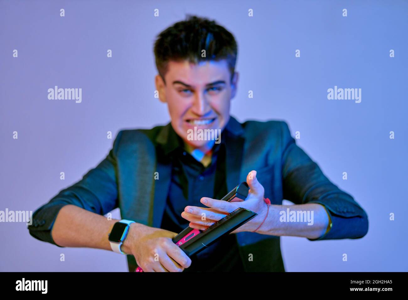 emotional stylist with curling iron Stock Photo - Alamy