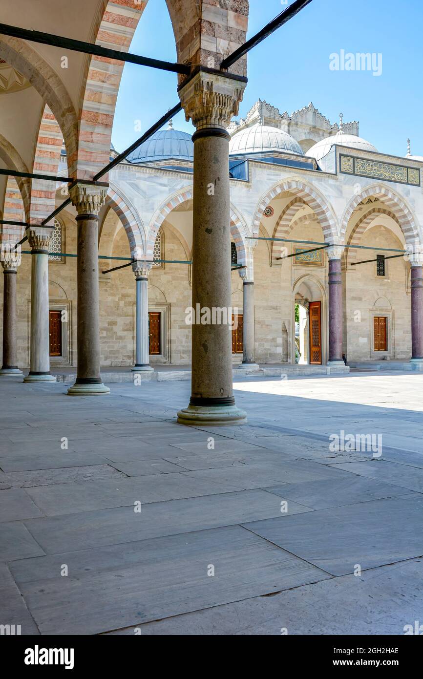 Inner courtyard and corridors with its arches and frescoes in the blue ...