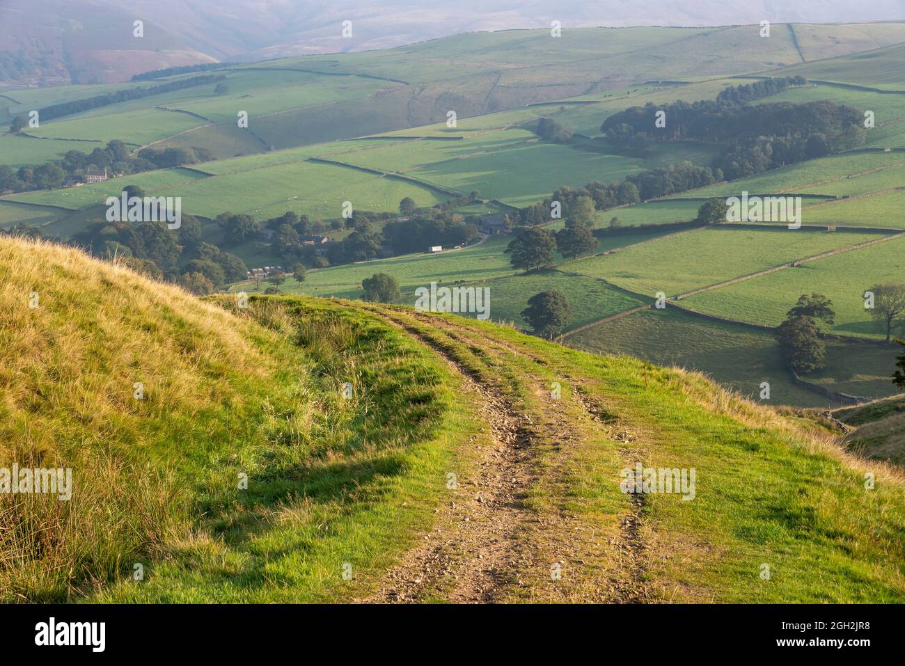 A hillside track near Hayfield, Derbyshire with view across the valley ...