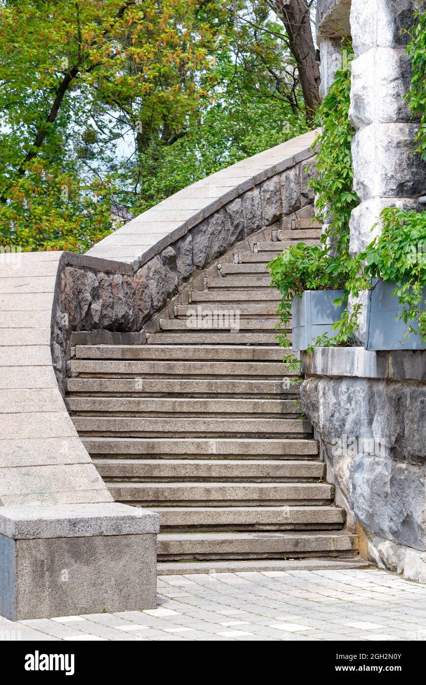 Massive stone staircase around an ancient castle in a green park ...