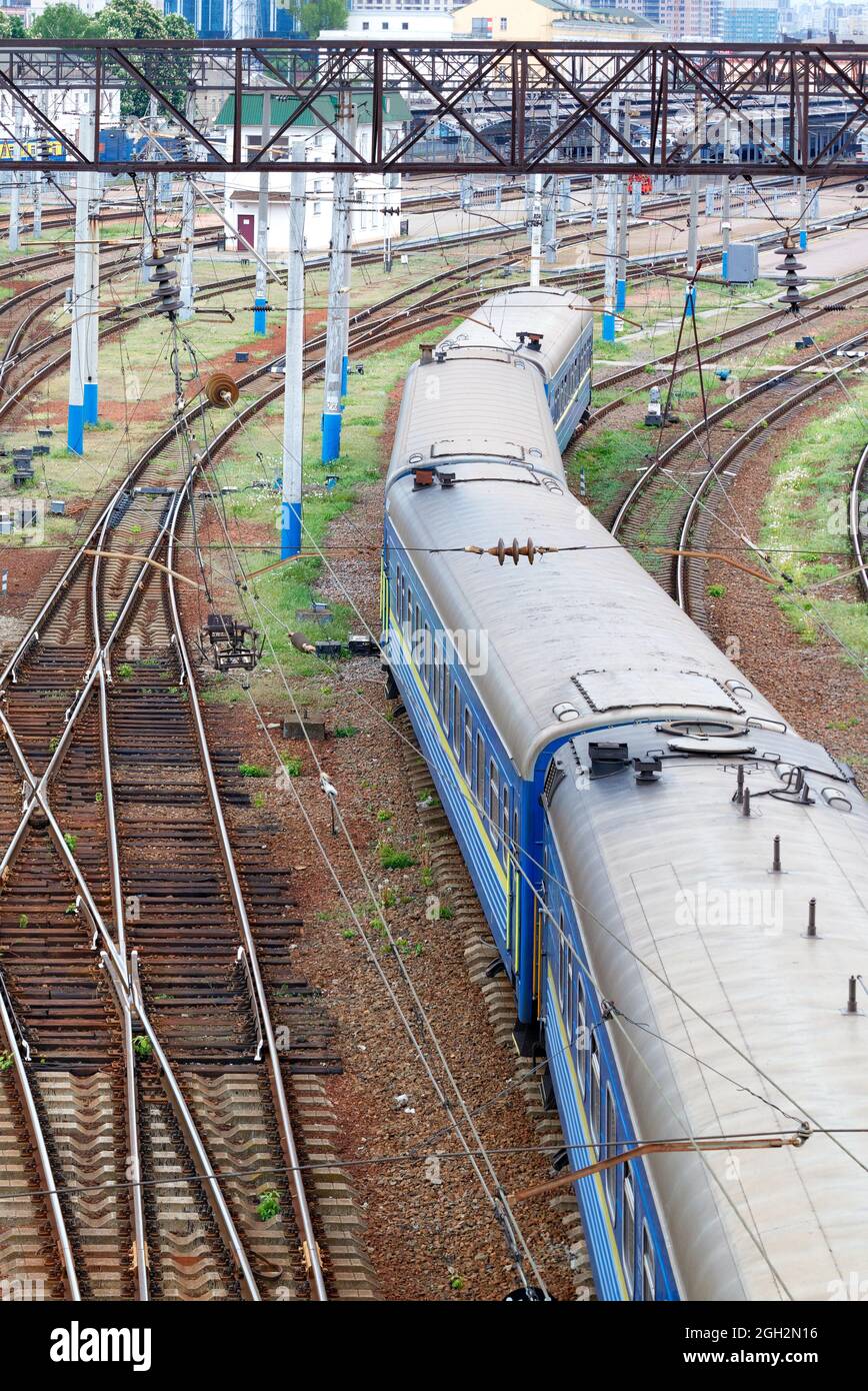 Multichannel rail network for trains in springtime, blue carriages of a ...