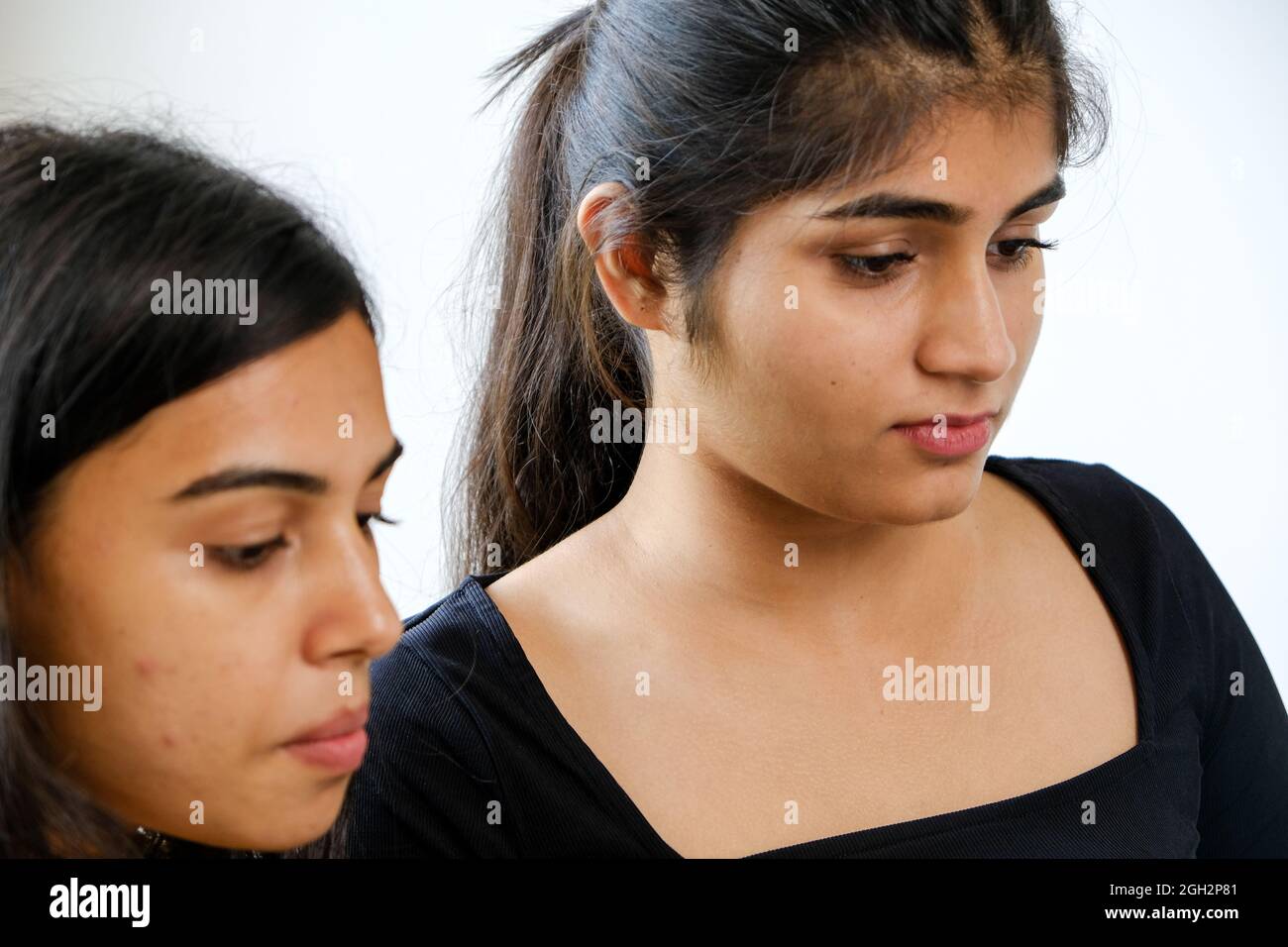 Young Indian girls having a discussion at home Stock Photo - Alamy