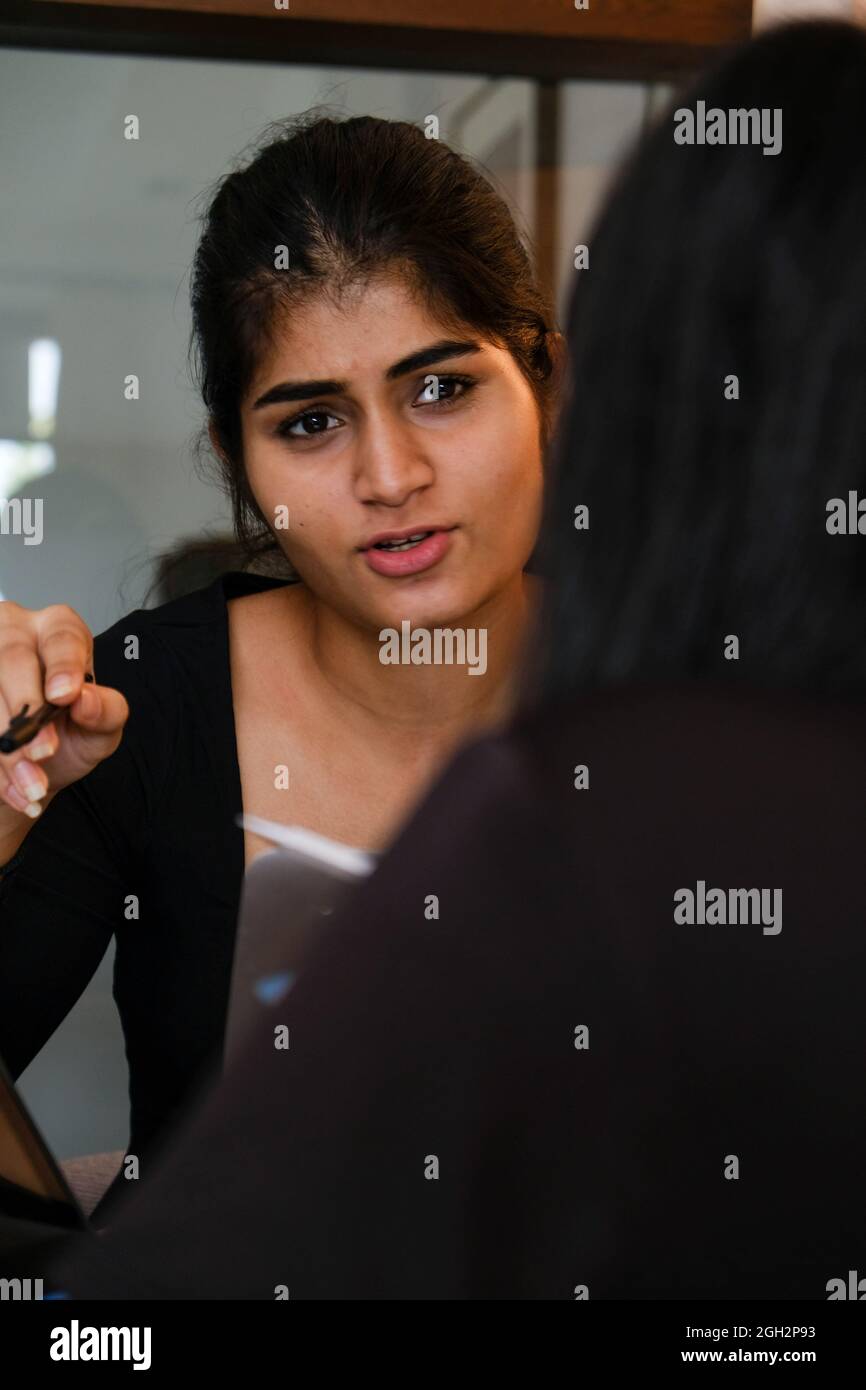 Young Indian girls having a discussion at home Stock Photo - Alamy