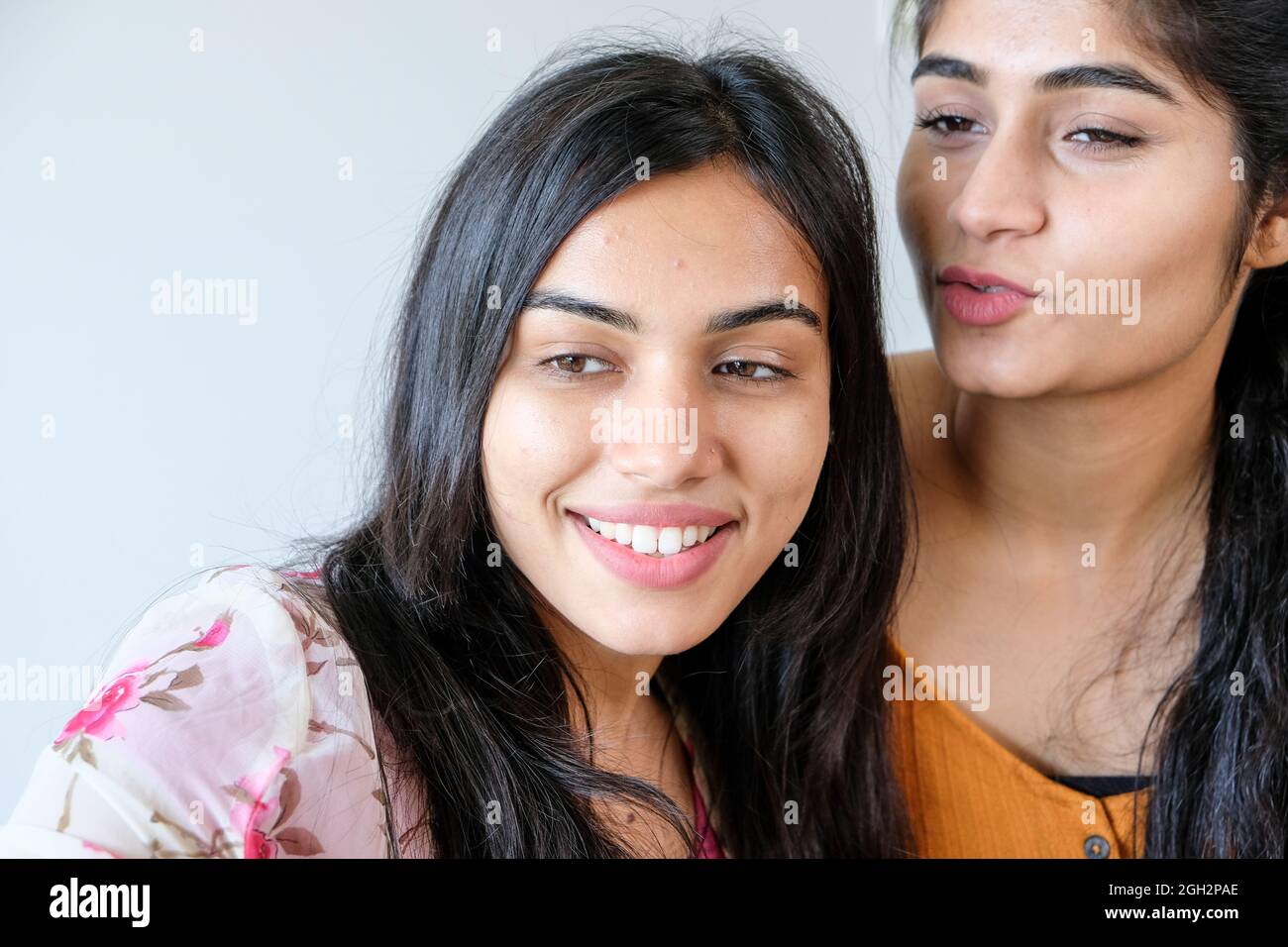 Two young beautiful Indian girls taking a selfie Stock Photo - Alamy