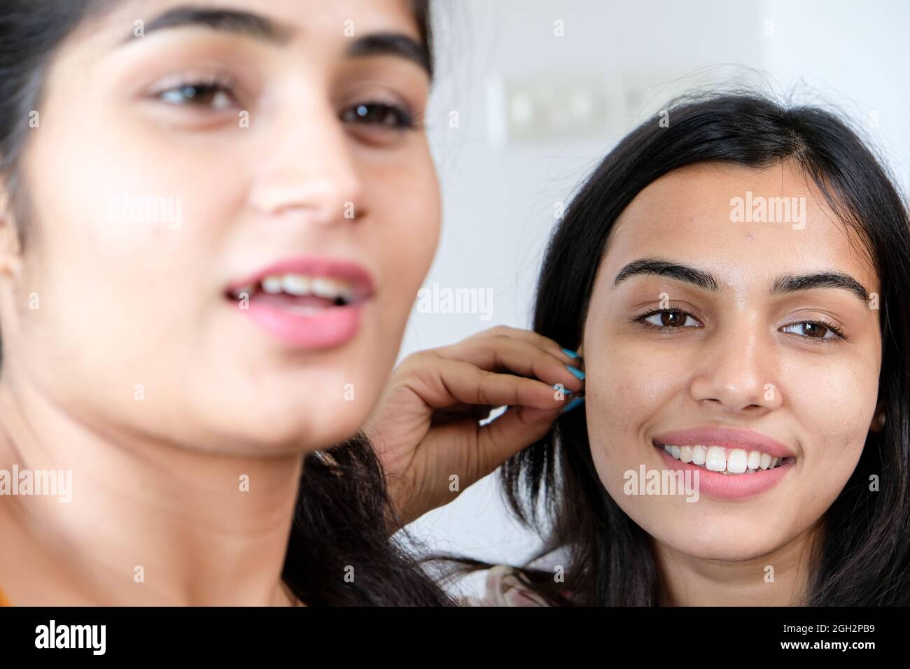 Young Indian girls having a discussion at home Stock Photo - Alamy
