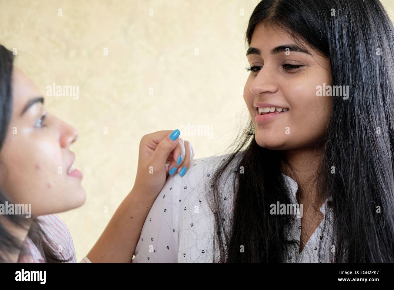 Young Indian girls having a discussion at home Stock Photo - Alamy