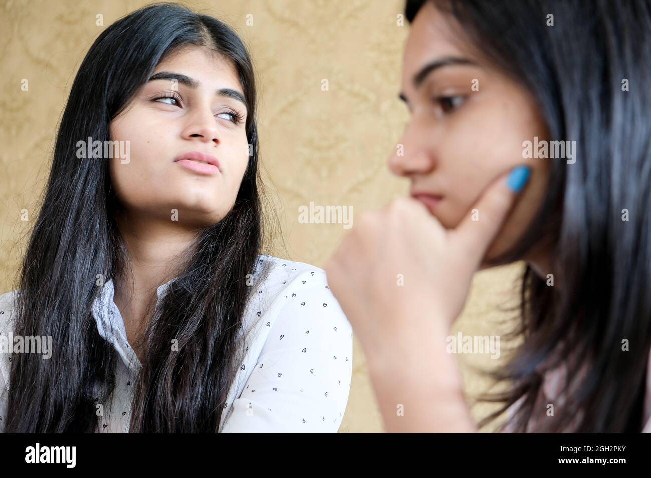 Young Indian girls having a discussion at home Stock Photo - Alamy