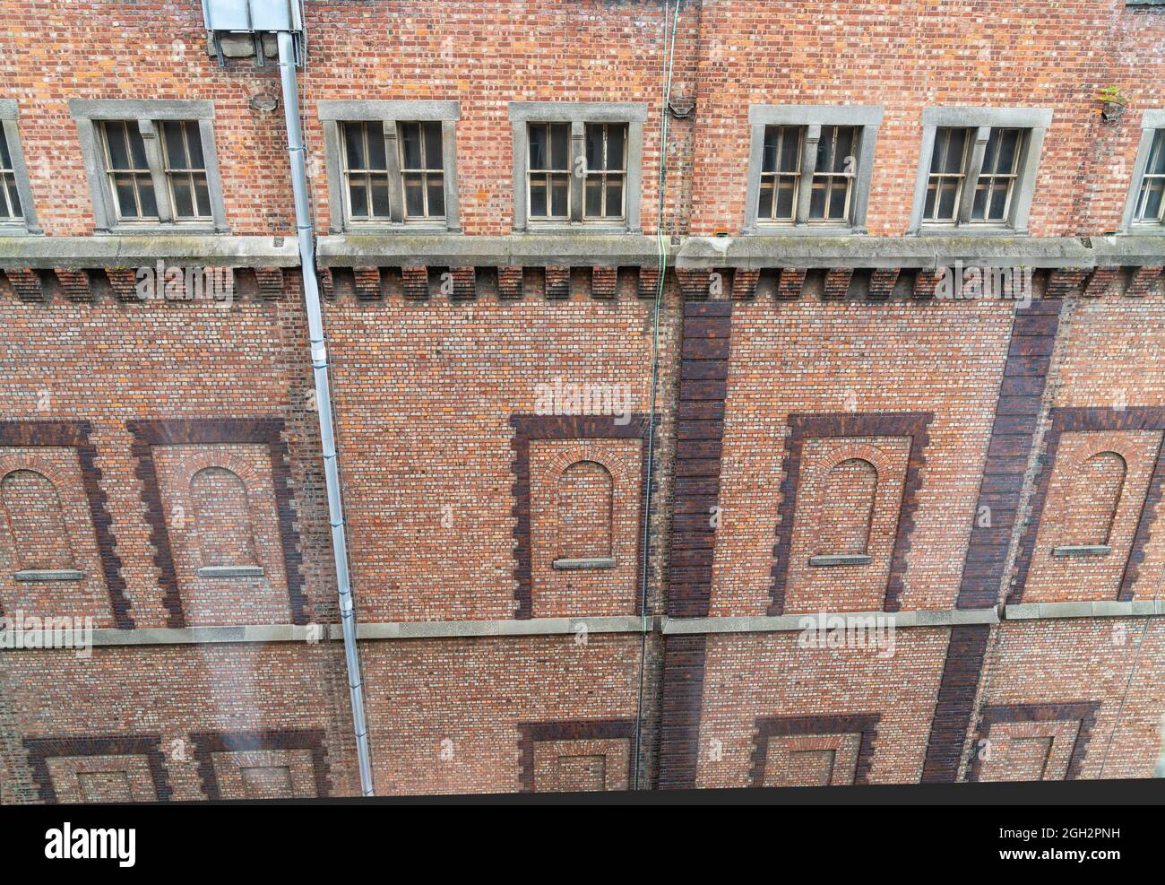 Brick wall or facade old heritage building exterior with down-pipe ...