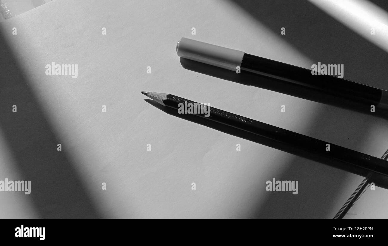 View of a marker and pencil on a paper in grayscale Stock Photo - Alamy