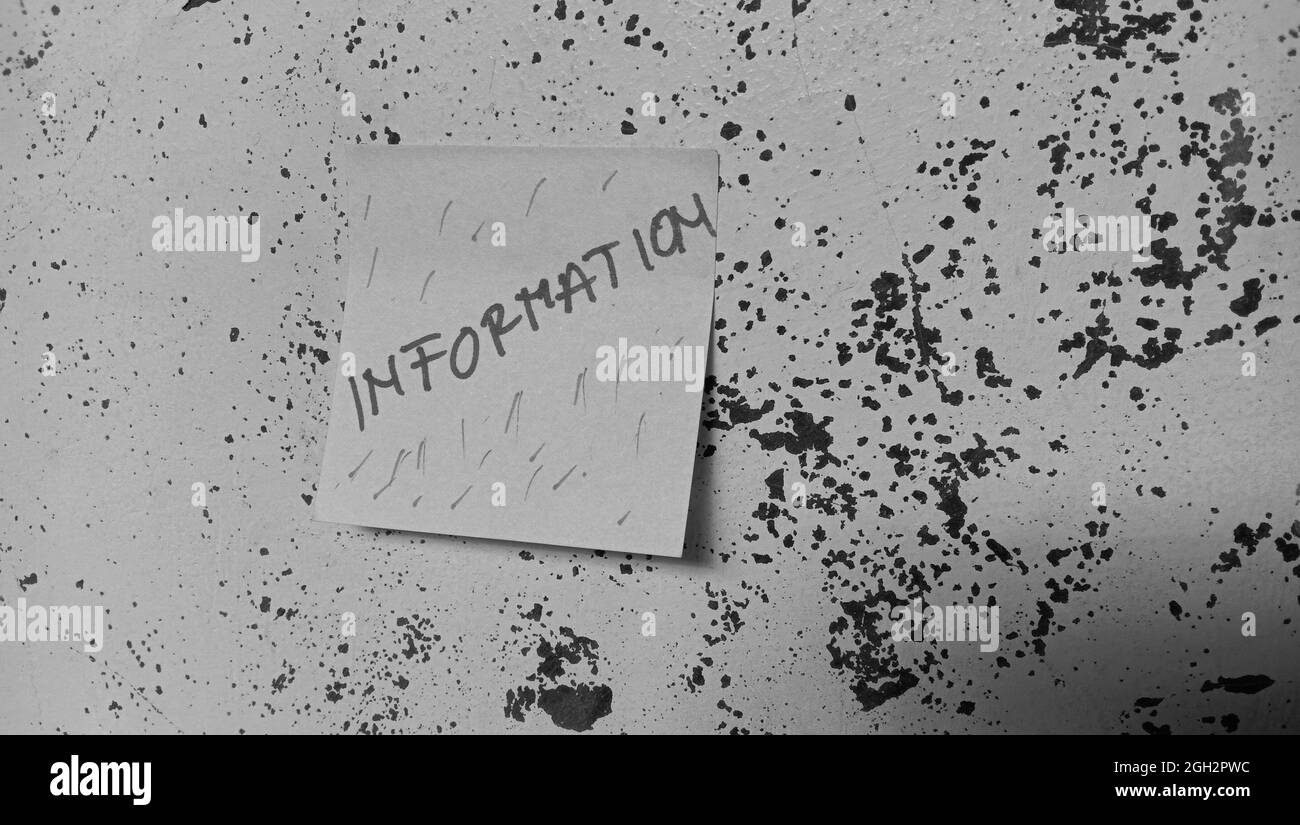 Wall with black spotted paints on it and a paper with the word ...