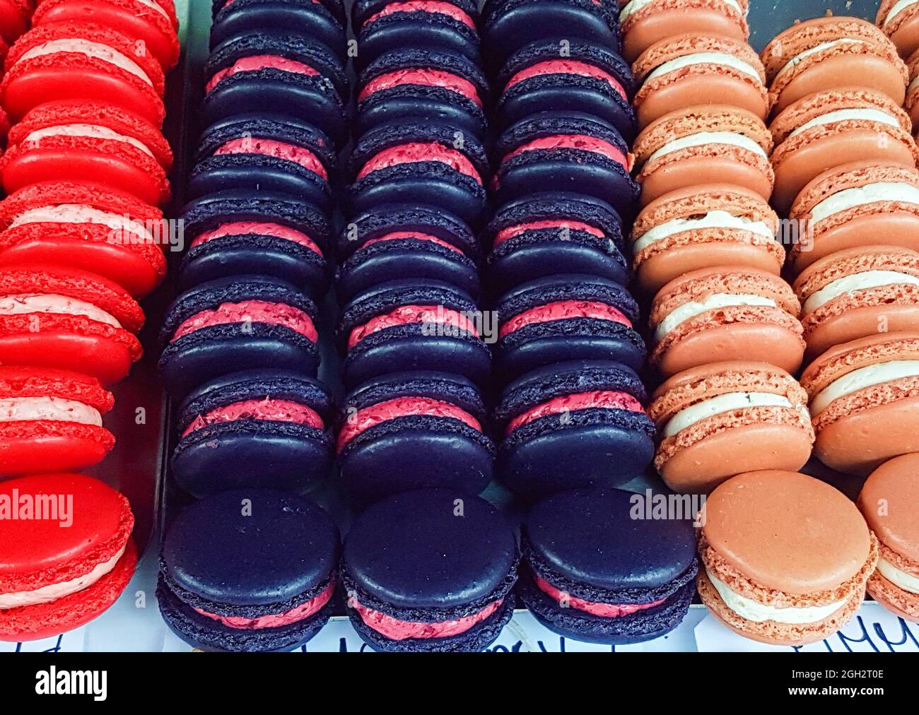 Rows of brightly colored macaroons for sale at market stall in London ...