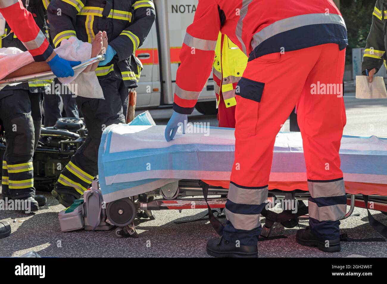 Rescue workers place victim on rescue stretcher Stock Photo - Alamy