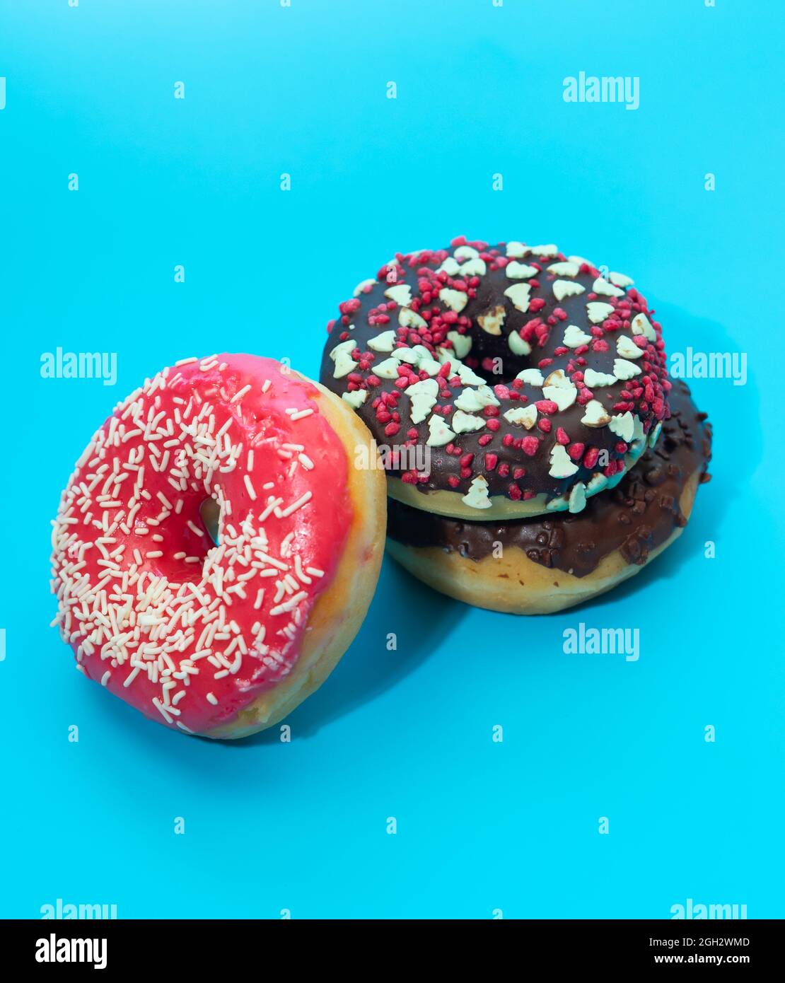 Colorful round donuts with filling on a blue background. Sweets.Flat ...