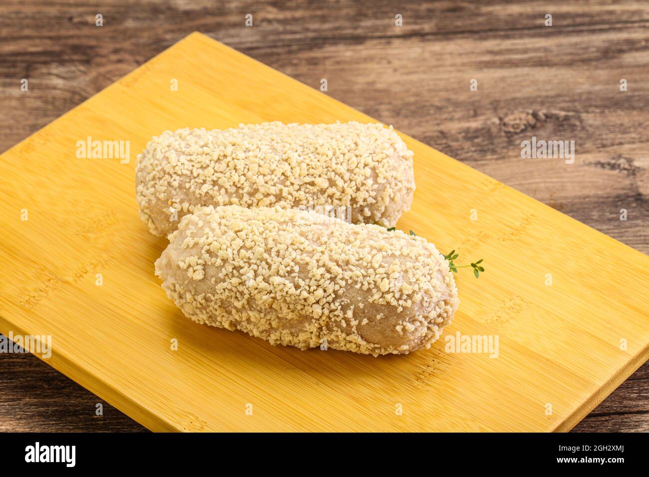 Raw breaded chicken cutlet for roast Stock Photo - Alamy