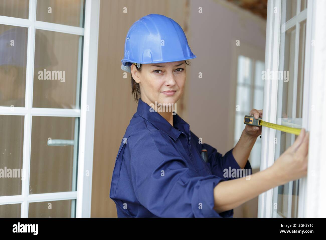 woman measuring a window with tape measure Stock Photo - Alamy