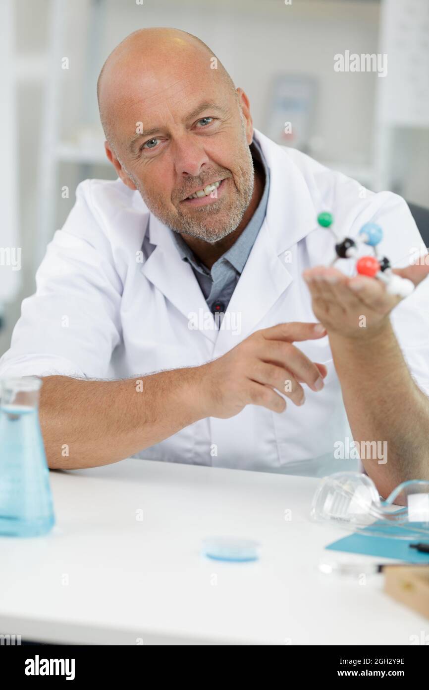 mature scientist making research over dna molecule structure Stock Photo - Alamy