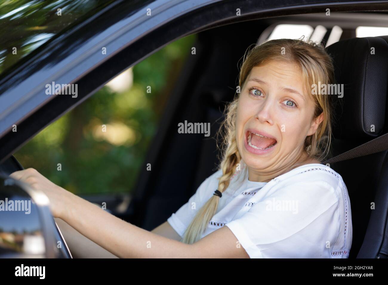young pretty woman scared in the car Stock Photo - Alamy