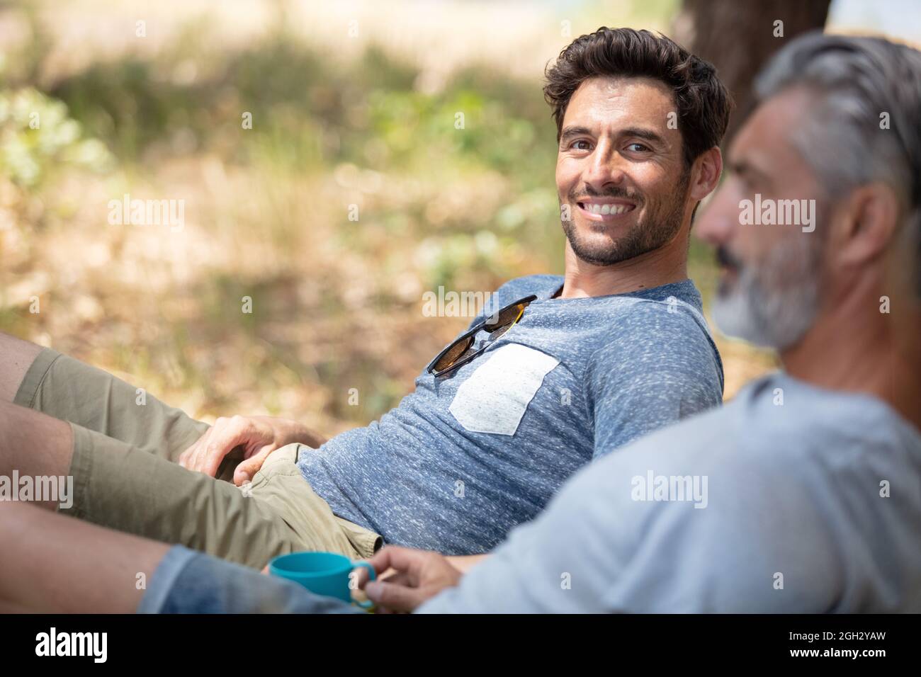men camping in the forest Stock Photo - Alamy