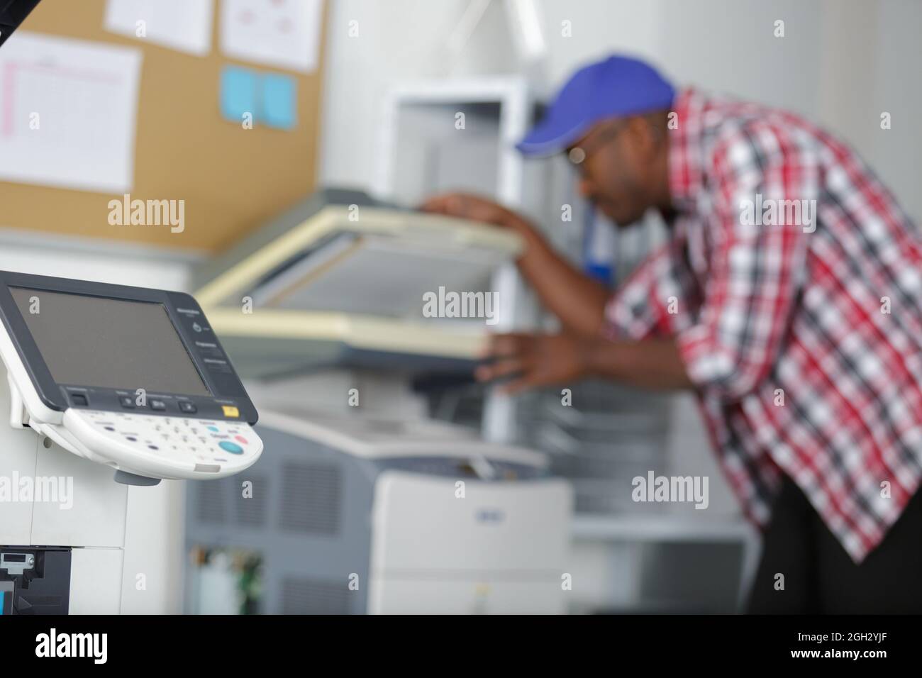 male technician fixing a printer Stock Photo - Alamy