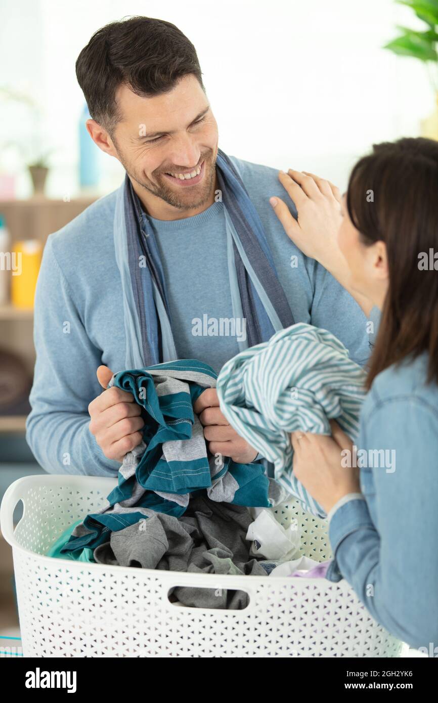 happy couple sorting laundry togather Stock Photo - Alamy