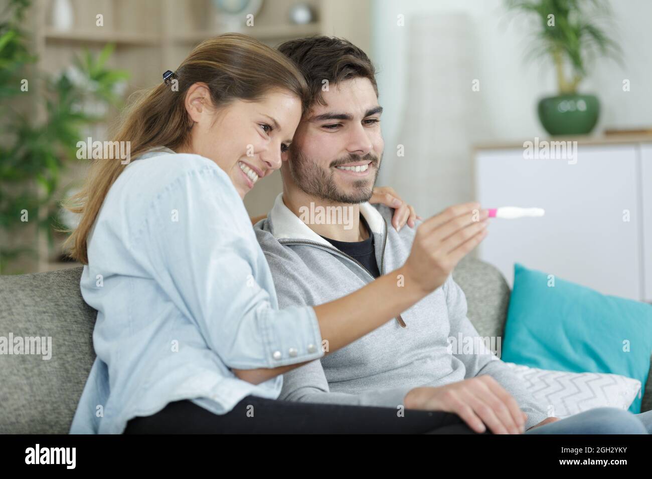 young couple is happy because of positive pregnancy test Stock Photo ...