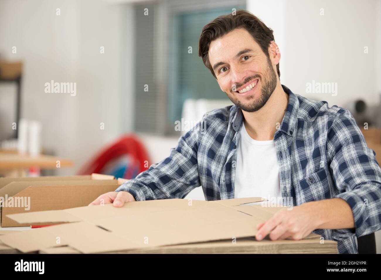 man with stack of cardboard box templates Stock Photo - Alamy