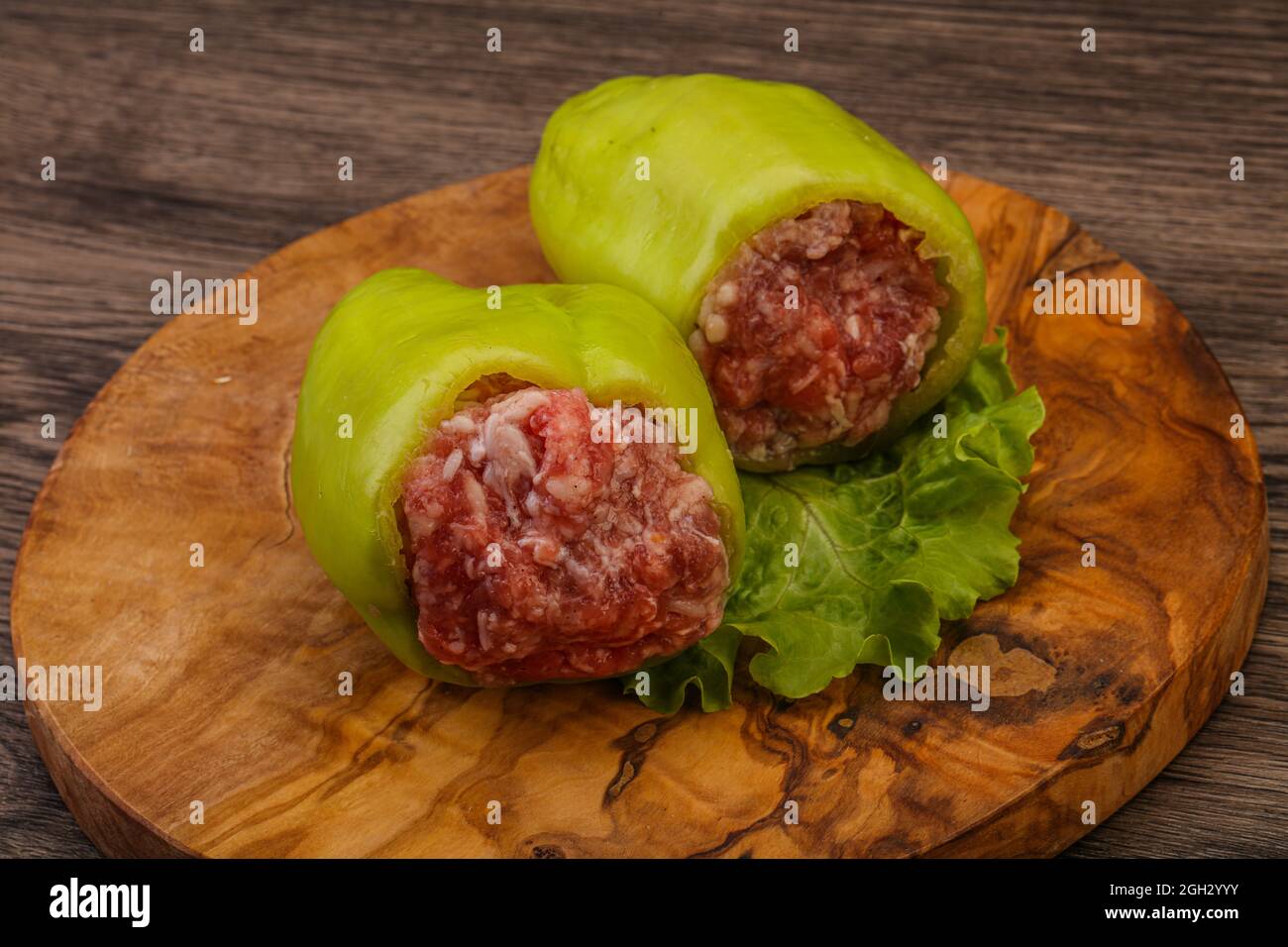 Raw stuffed green bell pepper with meat Stock Photo - Alamy