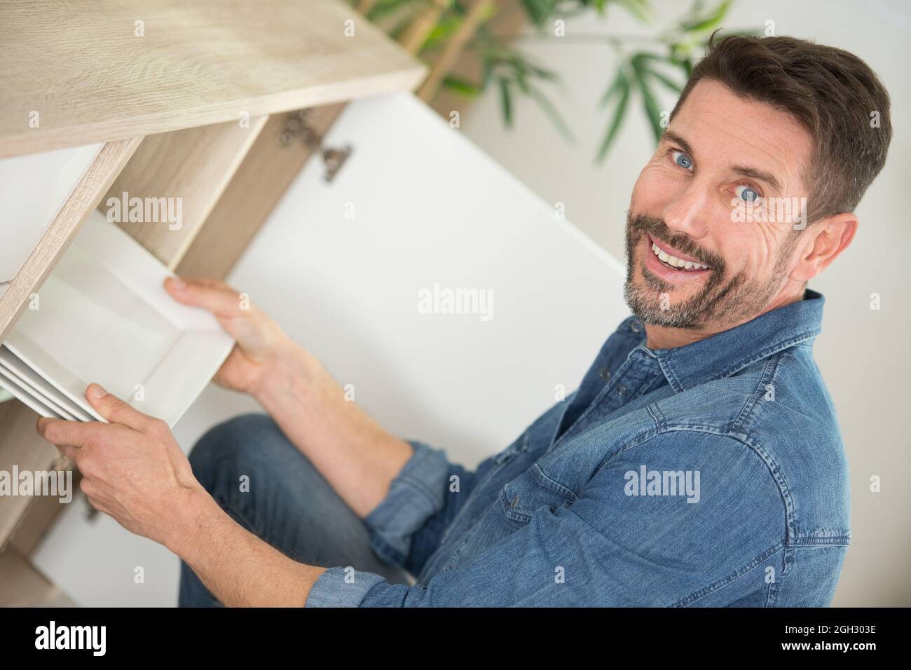 Reaching Into Cupboard High Resolution Stock Photography and Images - Alamy