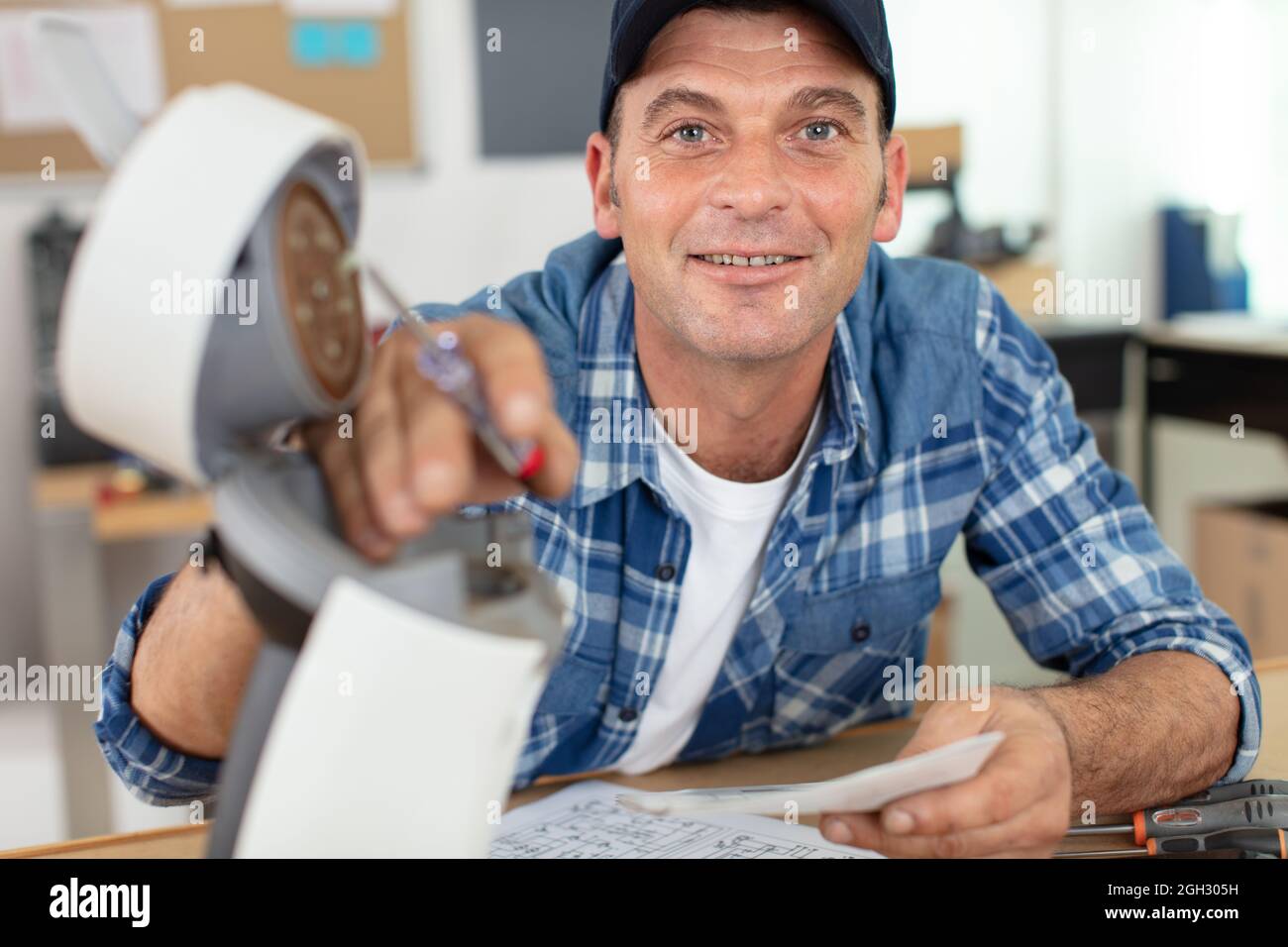 friendly man repairing broken coffee machine Stock Photo - Alamy