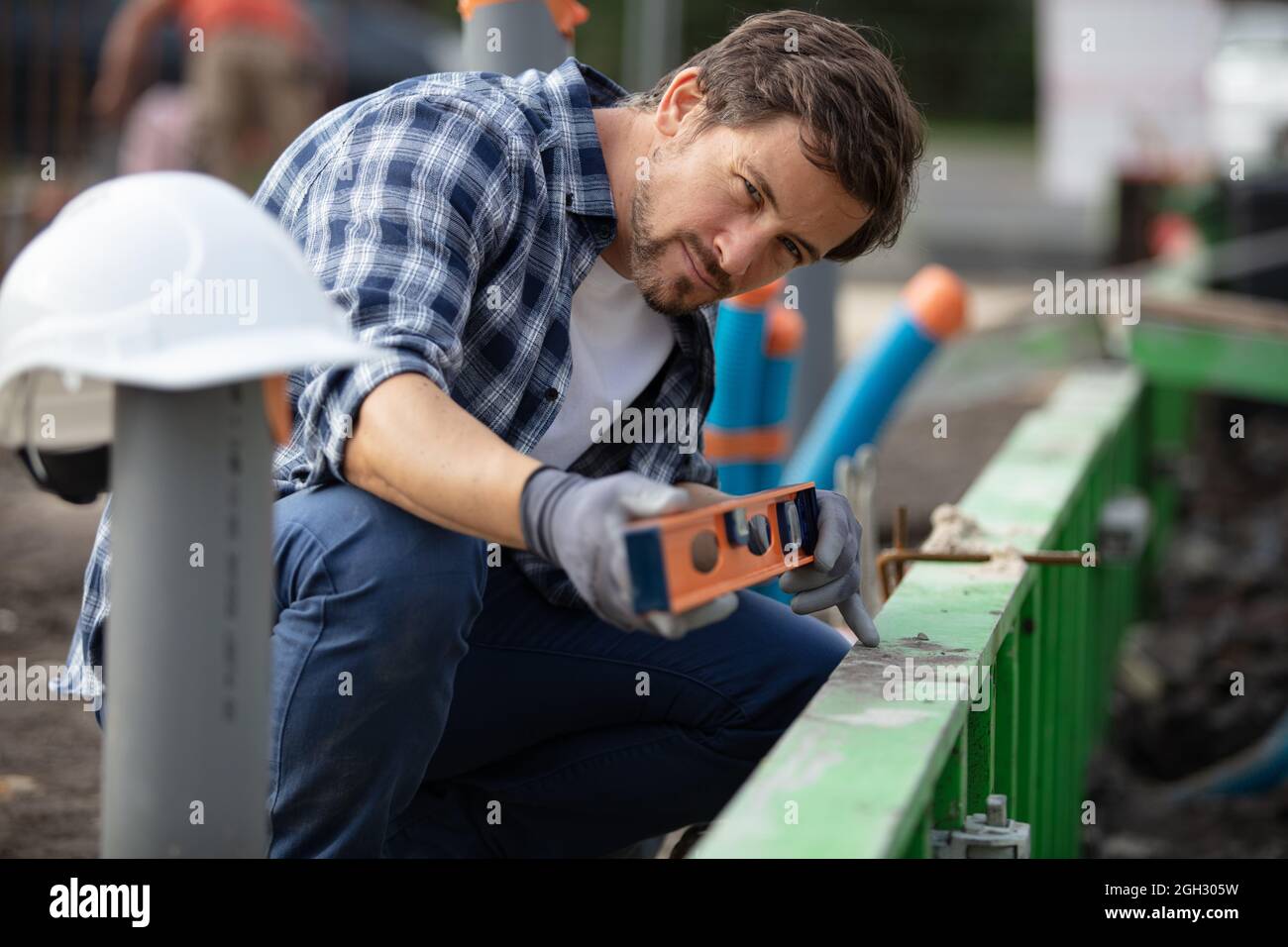 worker on the construction site conducts measurements Stock Photo - Alamy