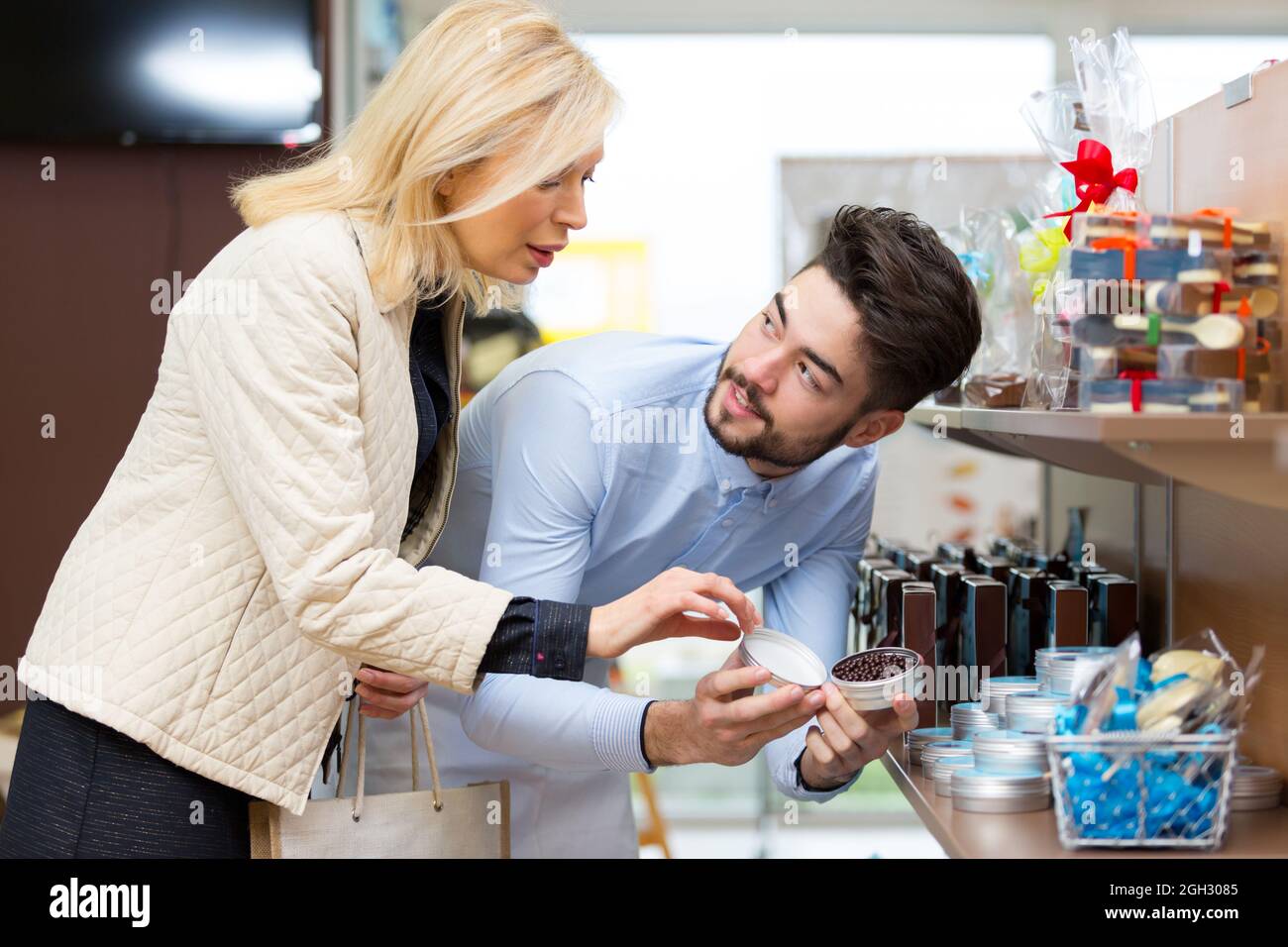 young man chooses chocolates in store Stock Photo - Alamy