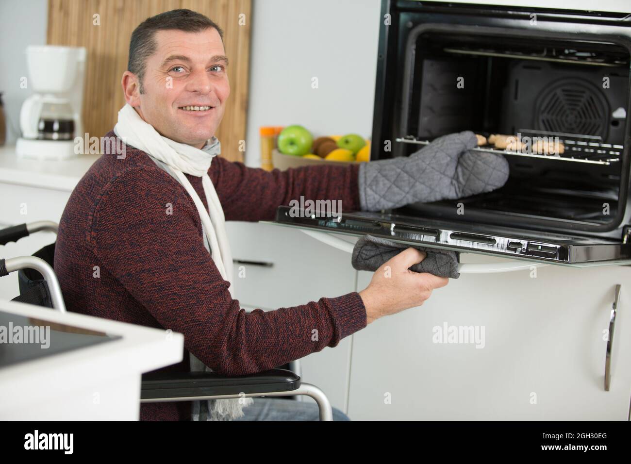 disabled man cooking at home Stock Photo - Alamy