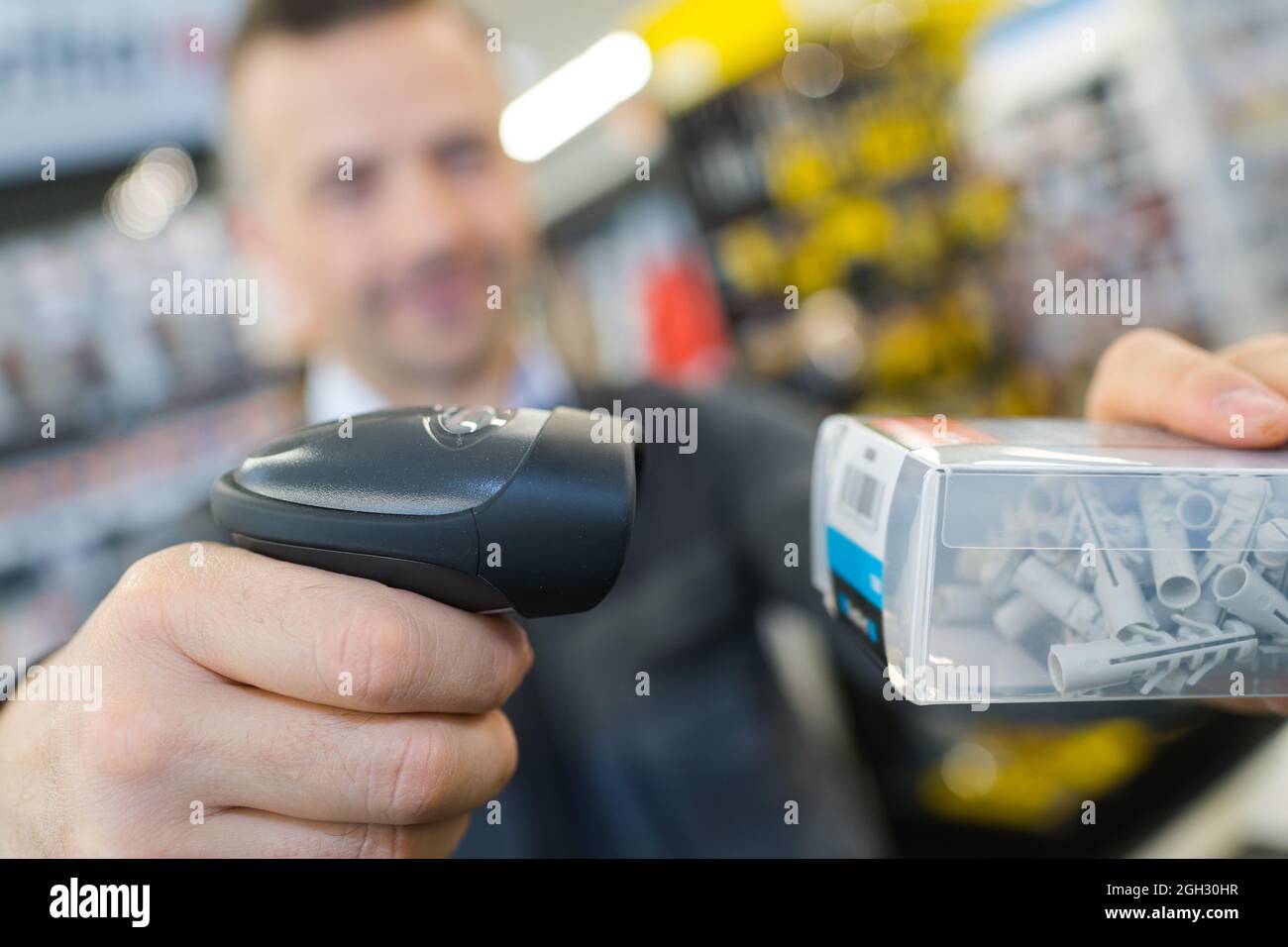 worker scanning products in hardware store Stock Photo - Alamy