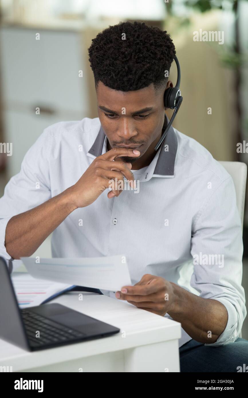 young help desk operator working in office Stock Photo - Alamy
