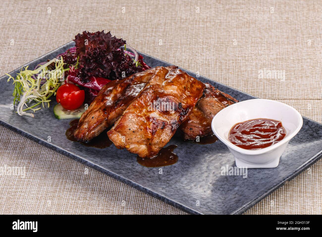 Grilled pork ribs with celery and carrot sticks Stock Photo - Alamy